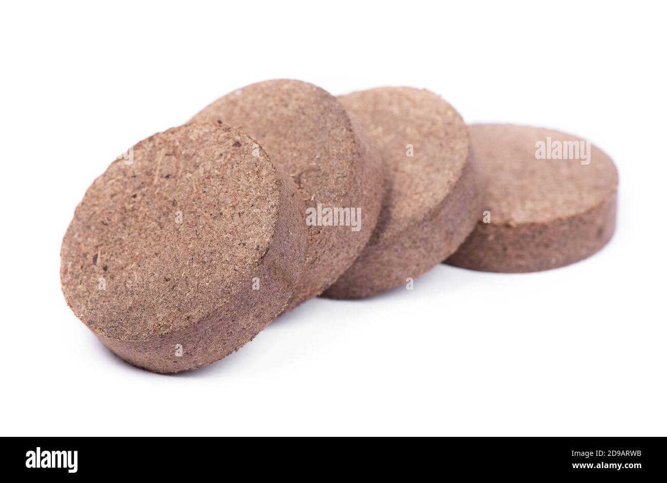 Dry peat pellets, compressed compost tablet isolated on white ...