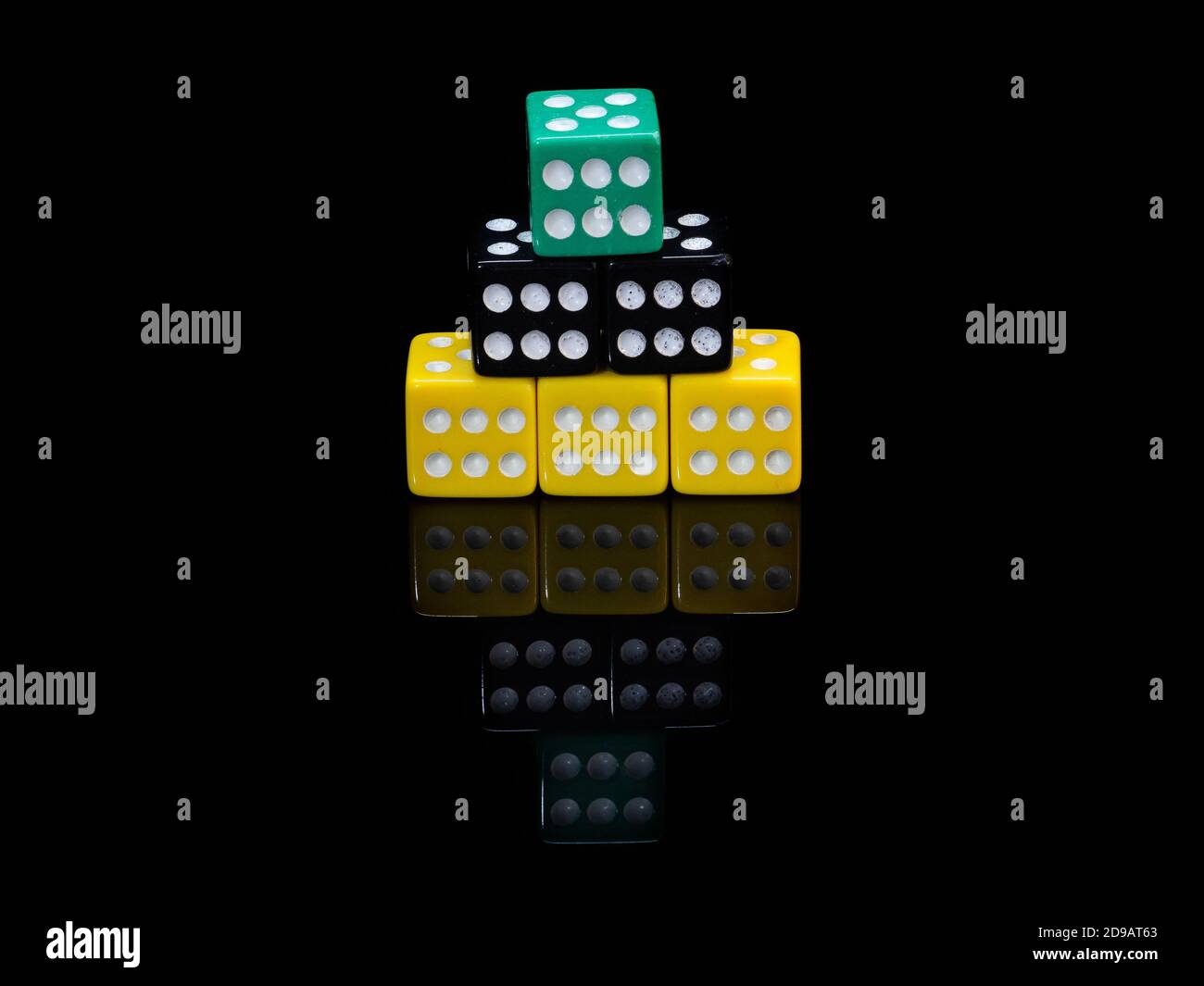 High angle shot of a pyramid of dice in various colors isolated on ...