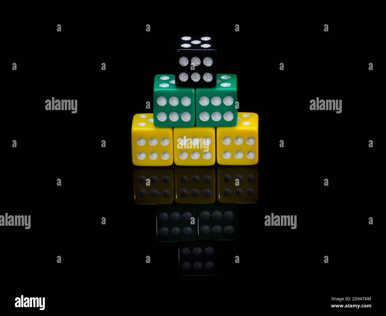 High angle shot of a pyramid of dice in various colors isolated on ...