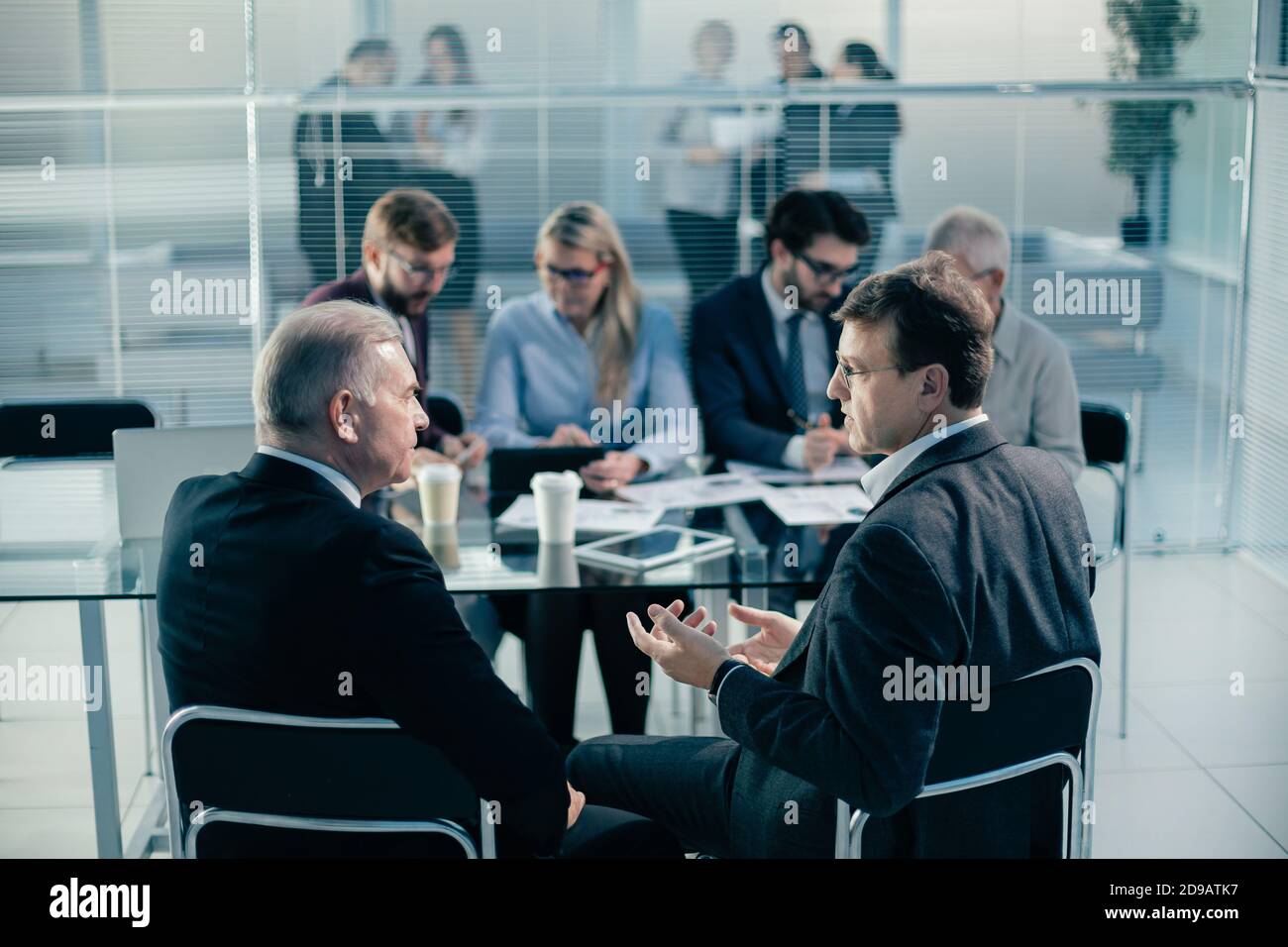 business colleagues discussing serious issues at an office meeting ...