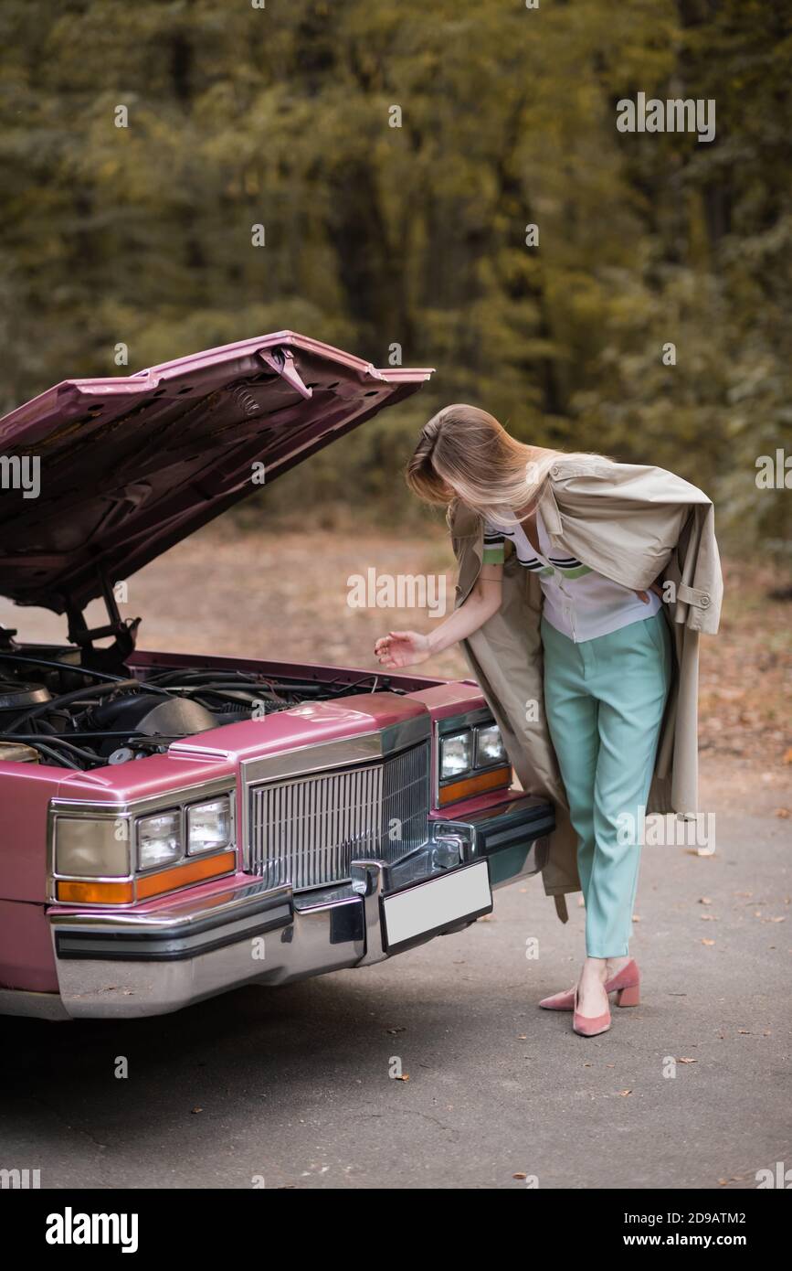 Woman looking under hood car hi-res stock photography and images - Alamy