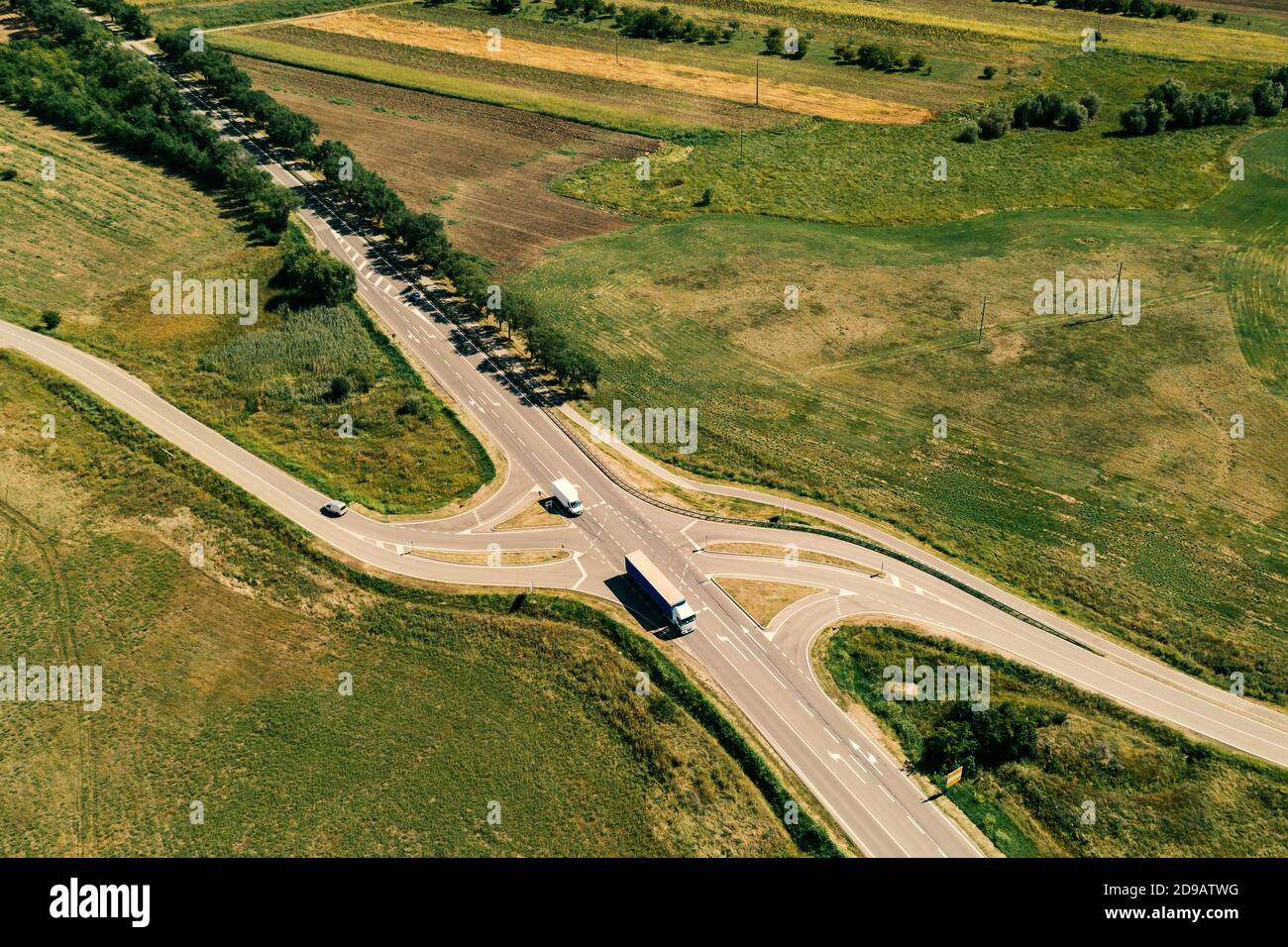 Aerial view of road intersection from drone pov with truck, lorry and ...