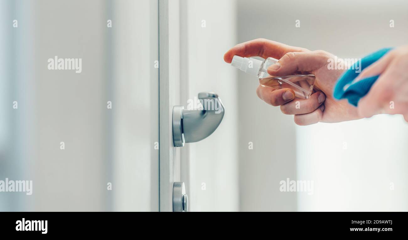 close up. man spraying antiseptic spray on the door handle Stock Photo ...