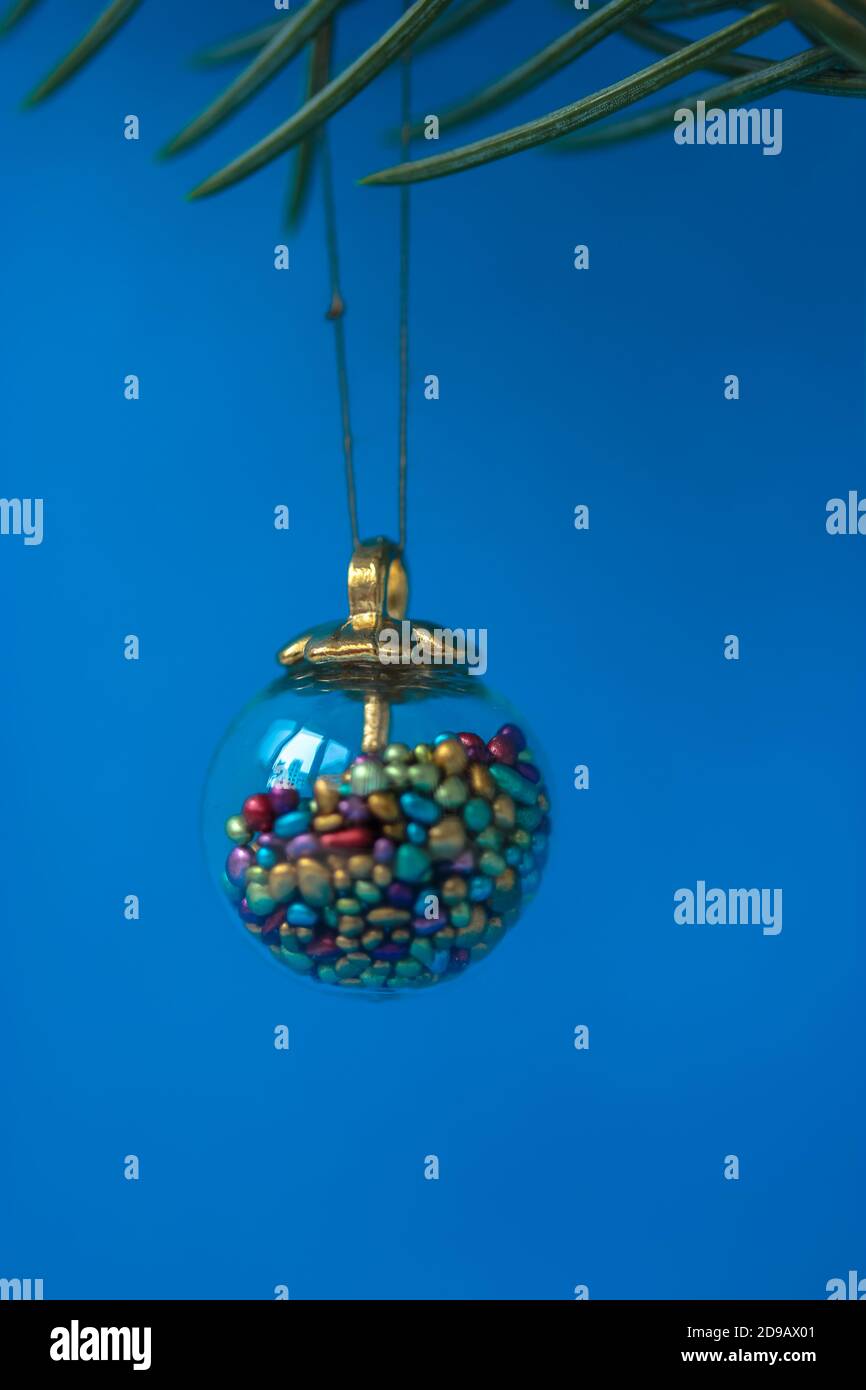 Beautiful Christmas tree toy in the form of a glass ball with colorful ...