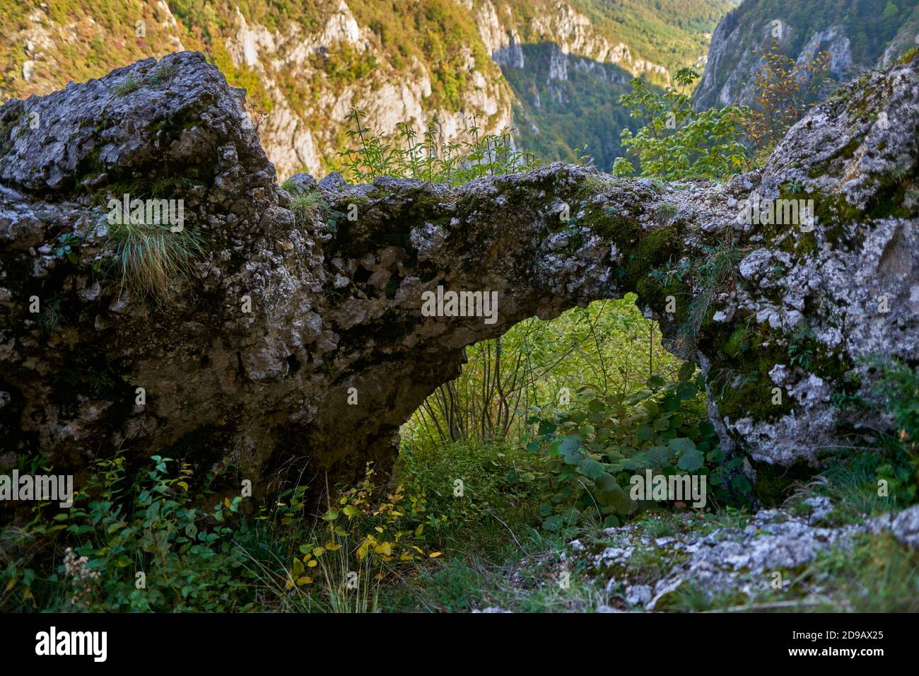 Natural stone arch in the mountains of Romania Stock Photo - Alamy