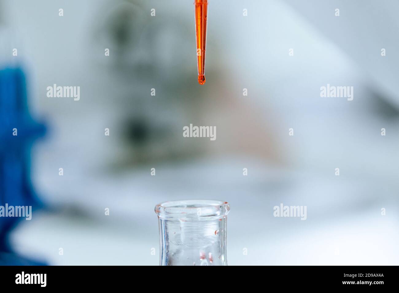 red liquid in a laboratory pipette on a blurry background Stock Photo ...