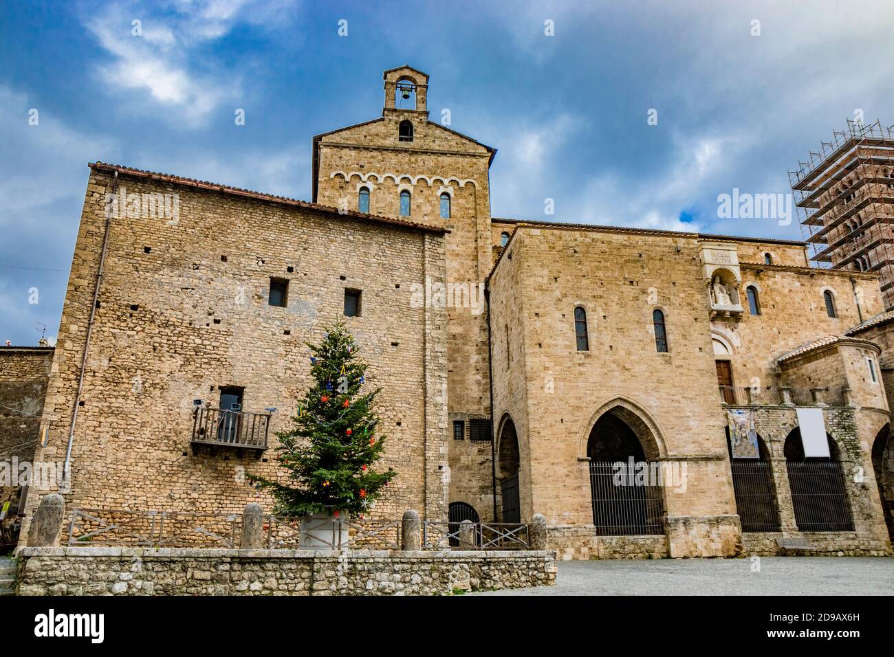 A large Christmas tree, decorated with colored balls, festoons and ...