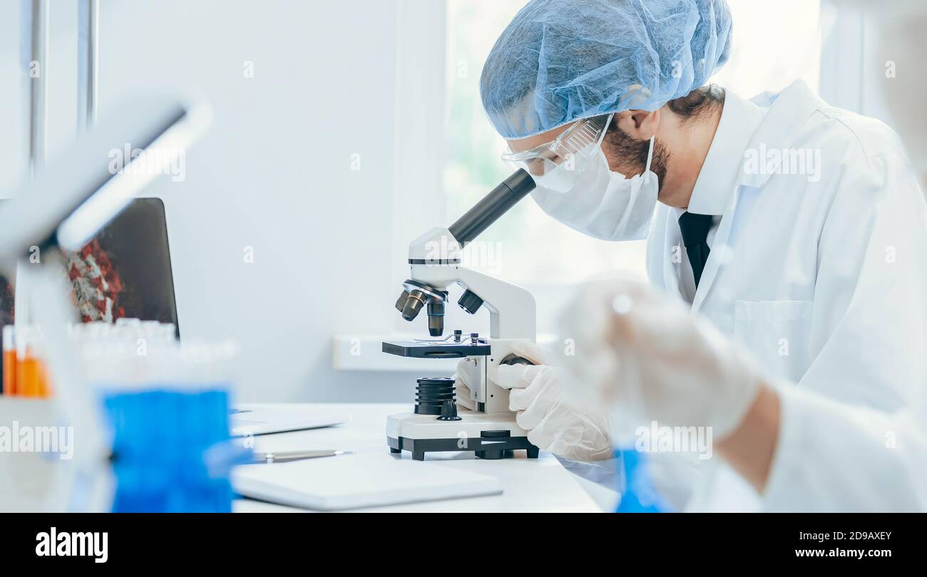 close up. a group of doctors and scientists work in the laboratory ...