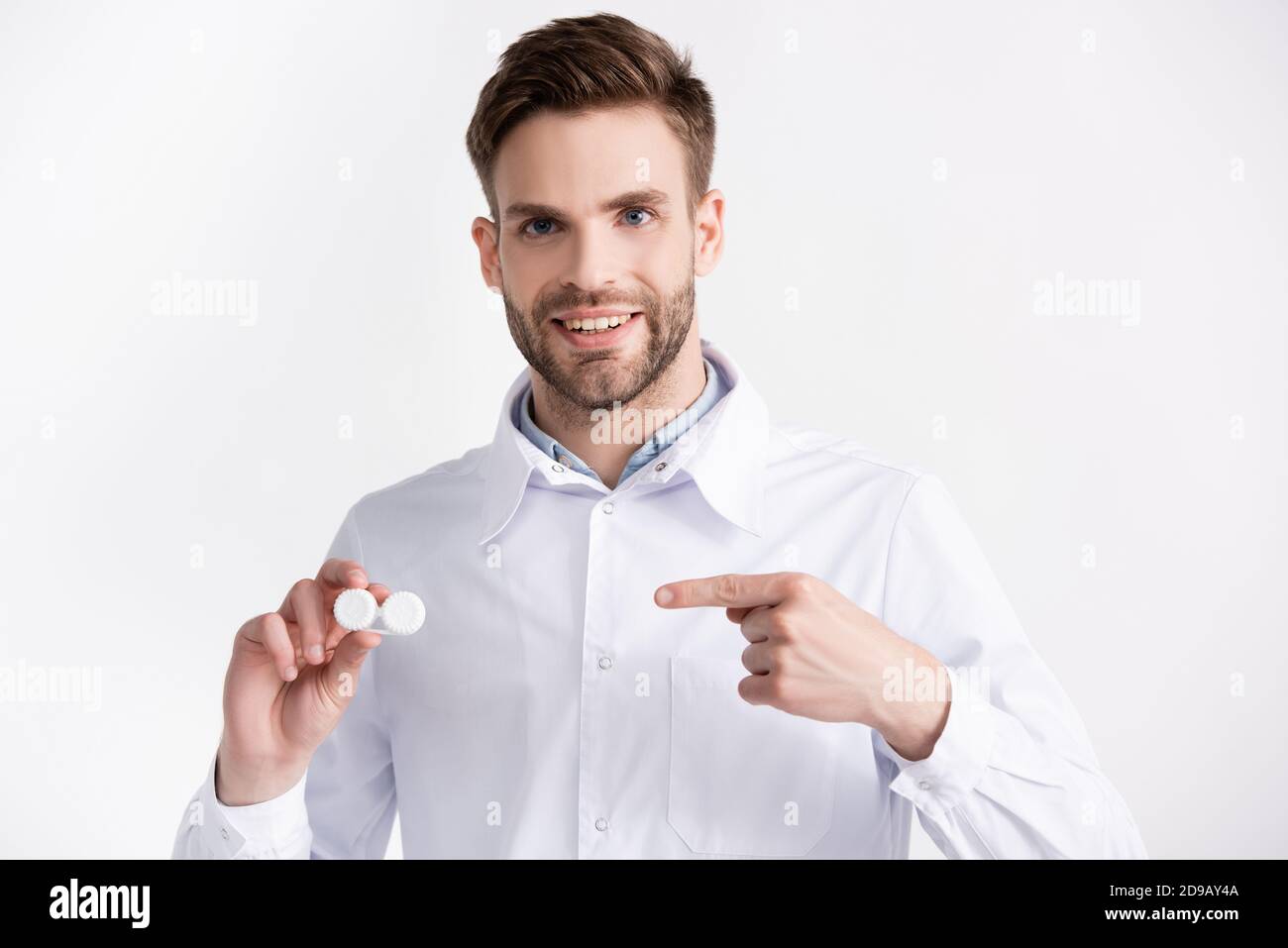 Front view of smiling doctor pointing with finger at lenses container ...
