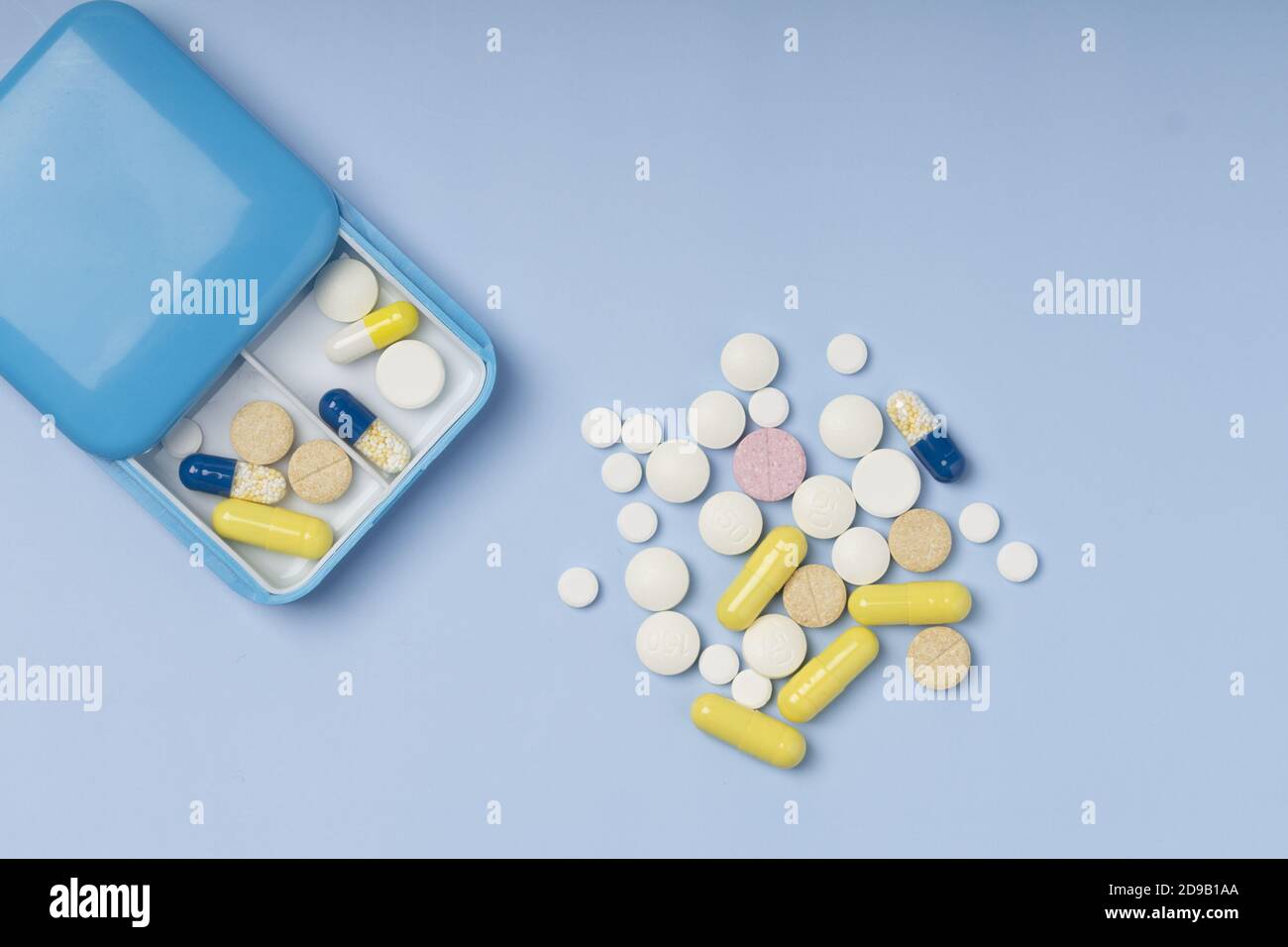 pill box with pills on blue background. box container of tablets ...