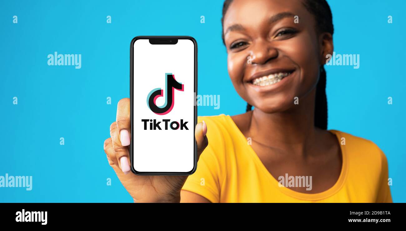 Black woman holding smart phone with Tik Tok app Stock Photo - Alamy