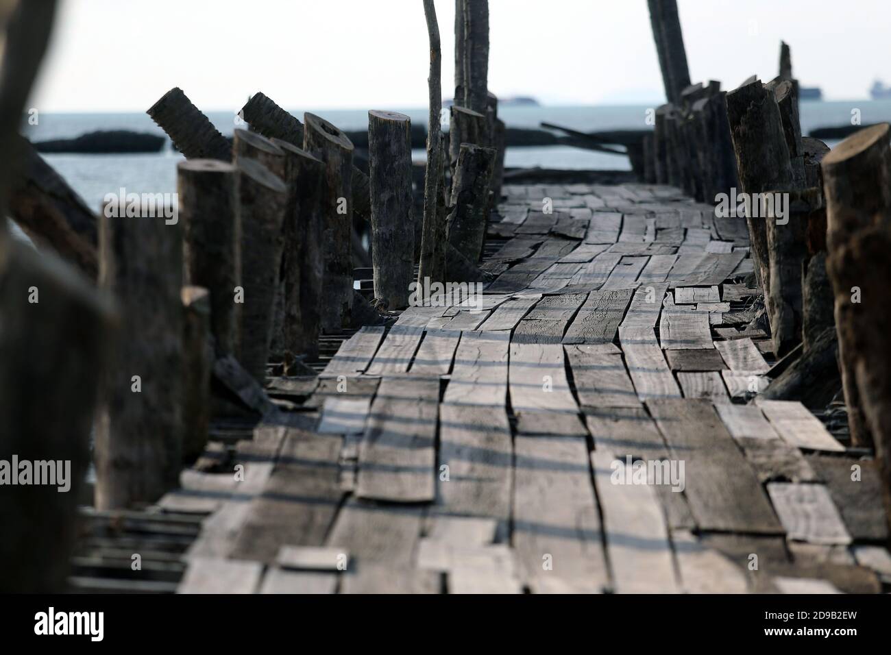 Old wood bridge to sea Stock Photo - Alamy