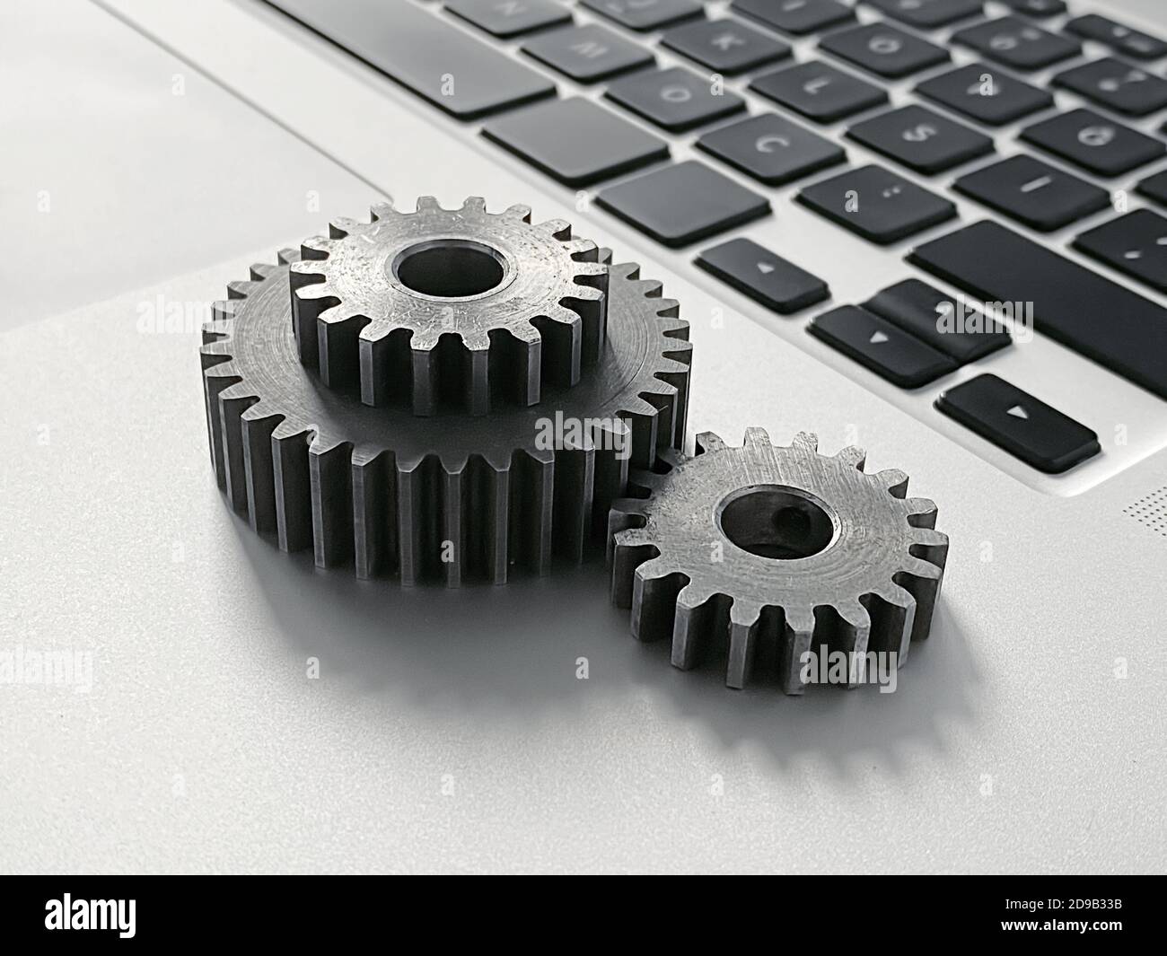 Cogwheels on top of a laptop computer Stock Photo - Alamy