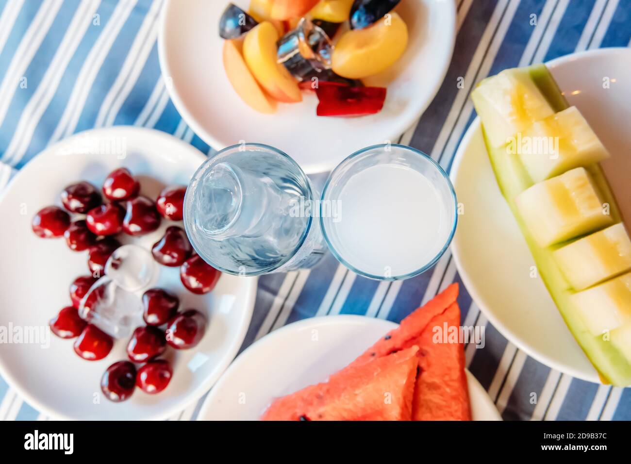 Greek Ouzo or Turkish raki with fruit salad and appetizers food in ...