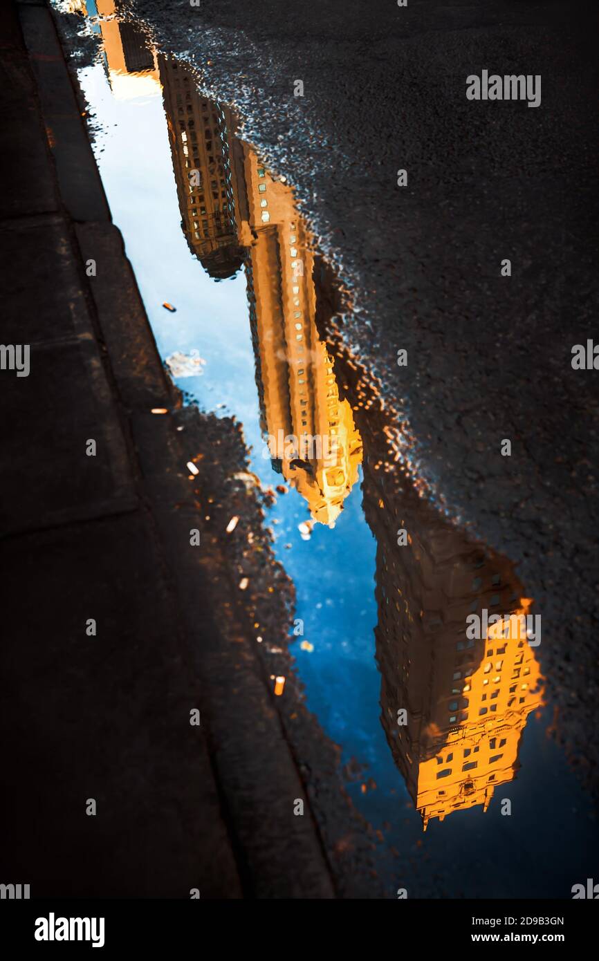 Skyscrapers reflection in puddles on the streets of Manhattan Stock ...