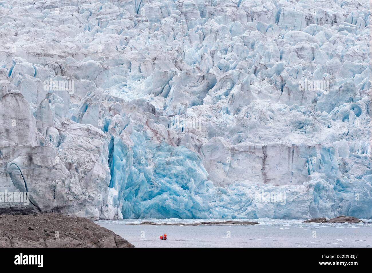 Scientists drive in dinghy close to Nordenskiold glacier. Svalbard ...