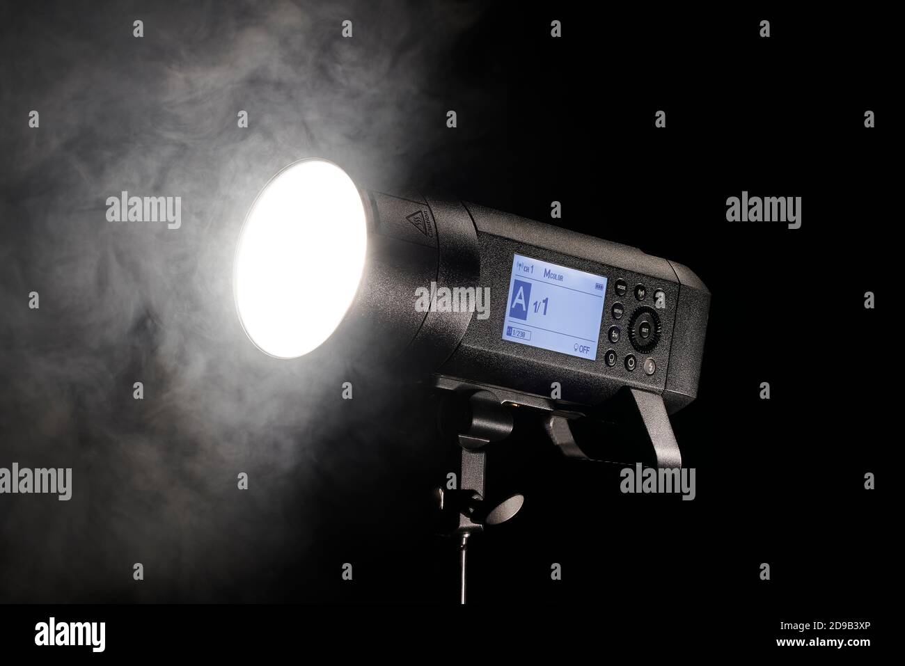 Studio flash light firing on black background with smoke Stock Photo ...