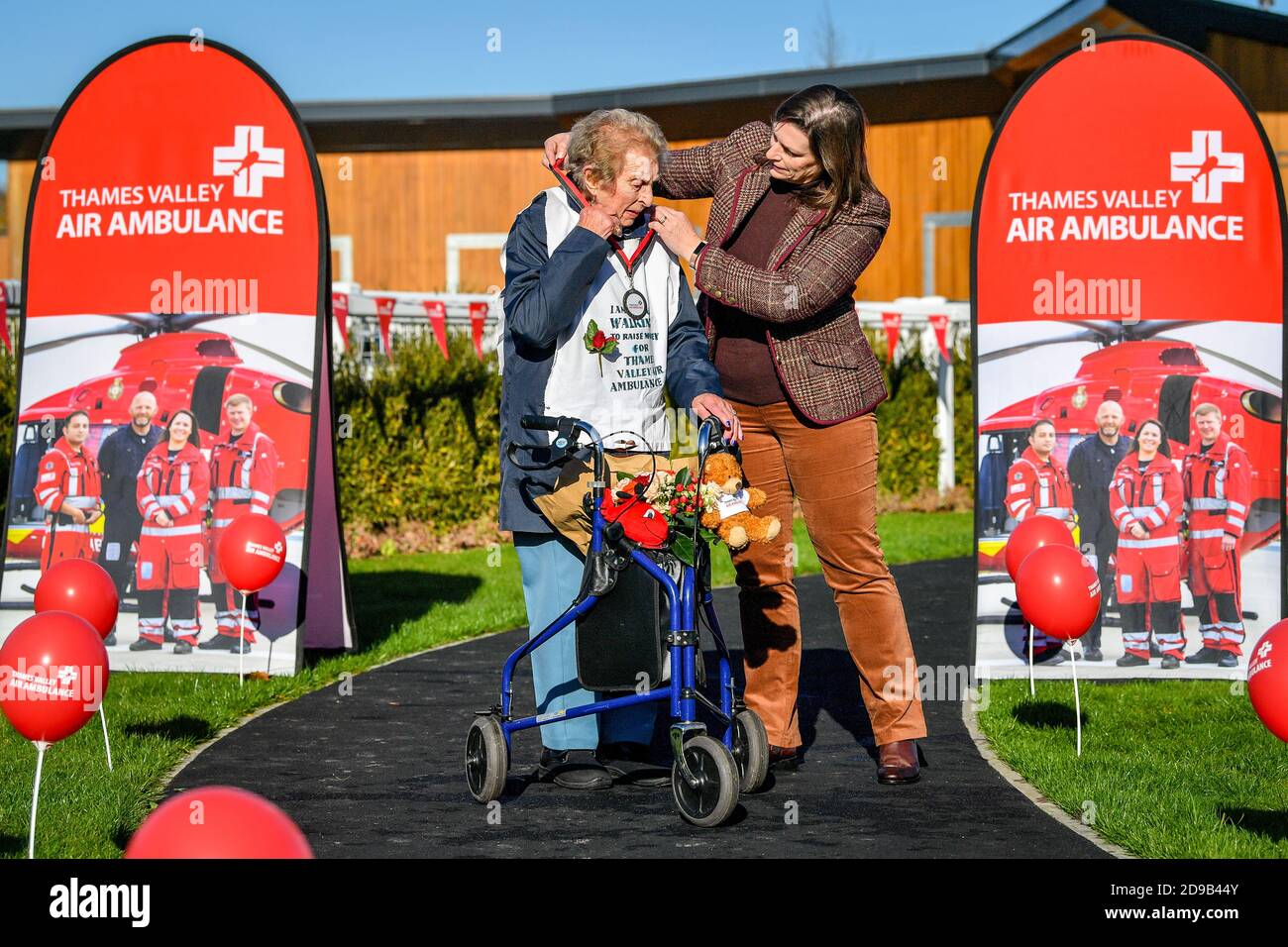 104-year-old Ruth Saunders is presented a medal by her daughter Kate ...