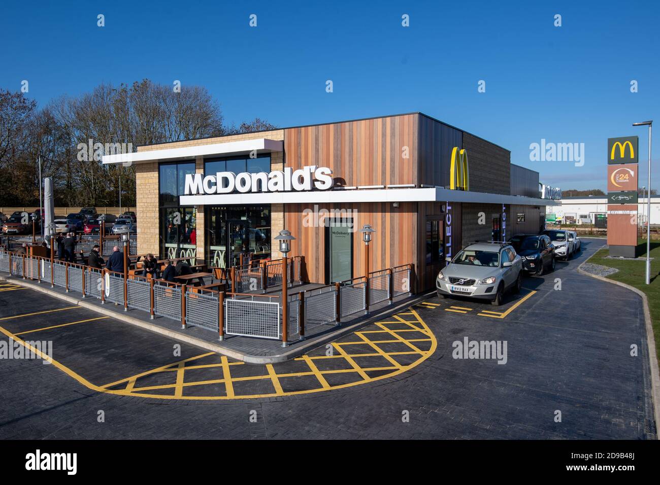 Cars queue at the drive thru of a new McDonald's restaurant, based on ...