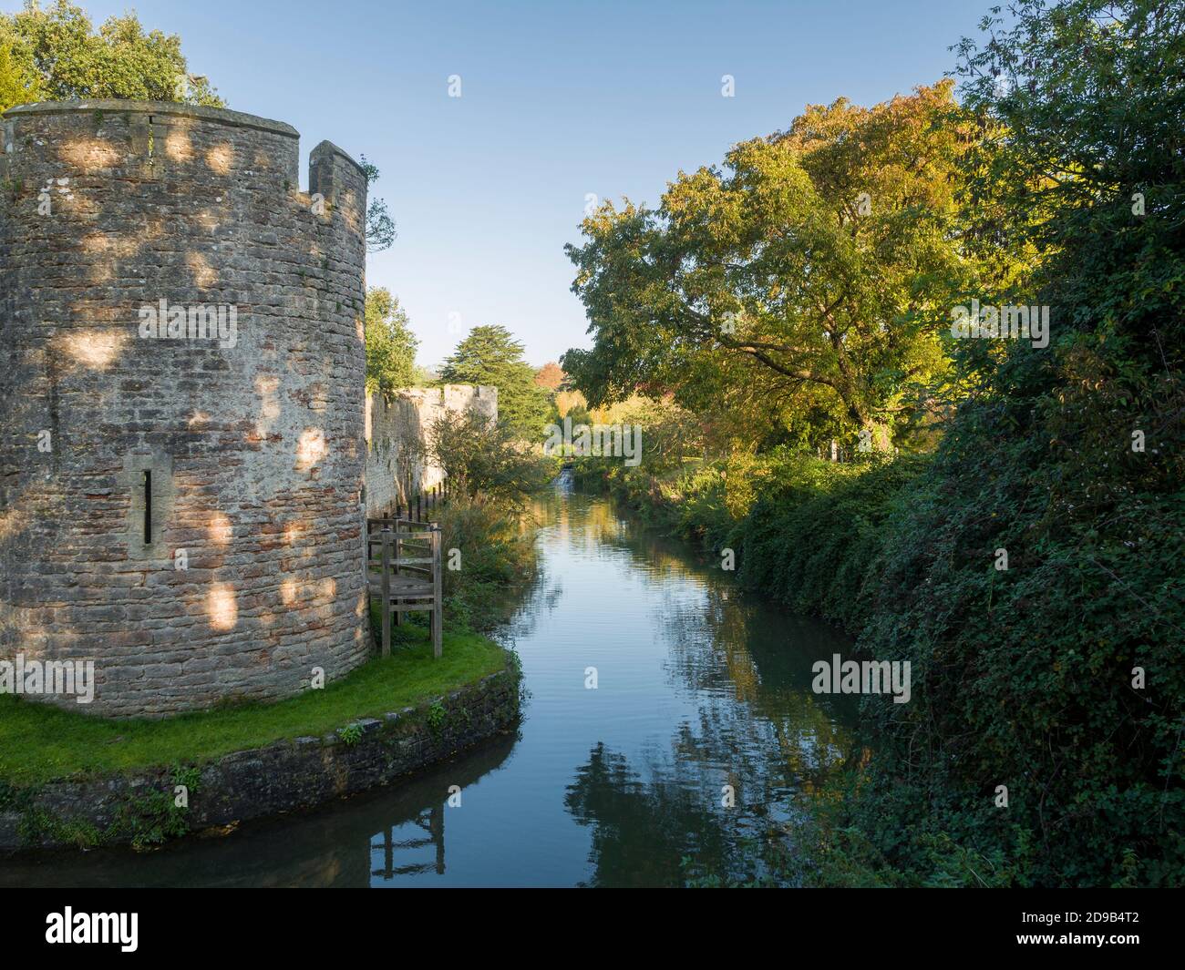 The Bishop's Palace moat and wall in autumn in the city of Wells ...