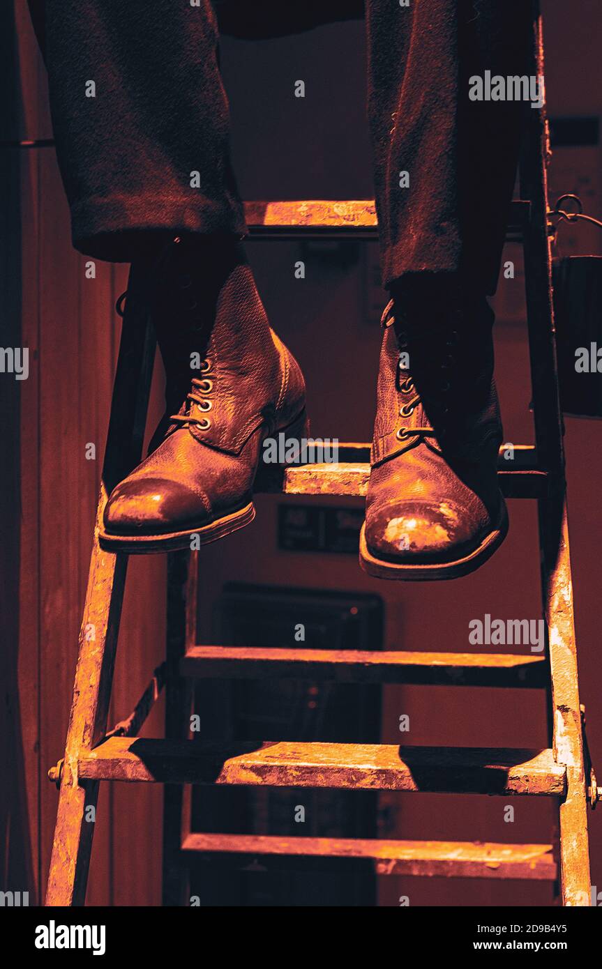 Man sitting on ladder Stock Photo - Alamy