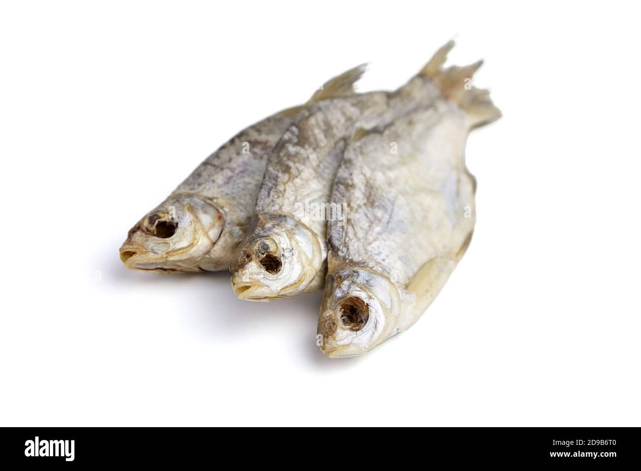 Three dry fish closeup isolated on white background, beer snack, top ...