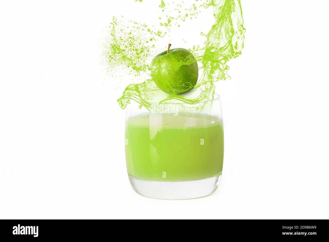 splashing apple juice with fresh apple in a glass against white ...
