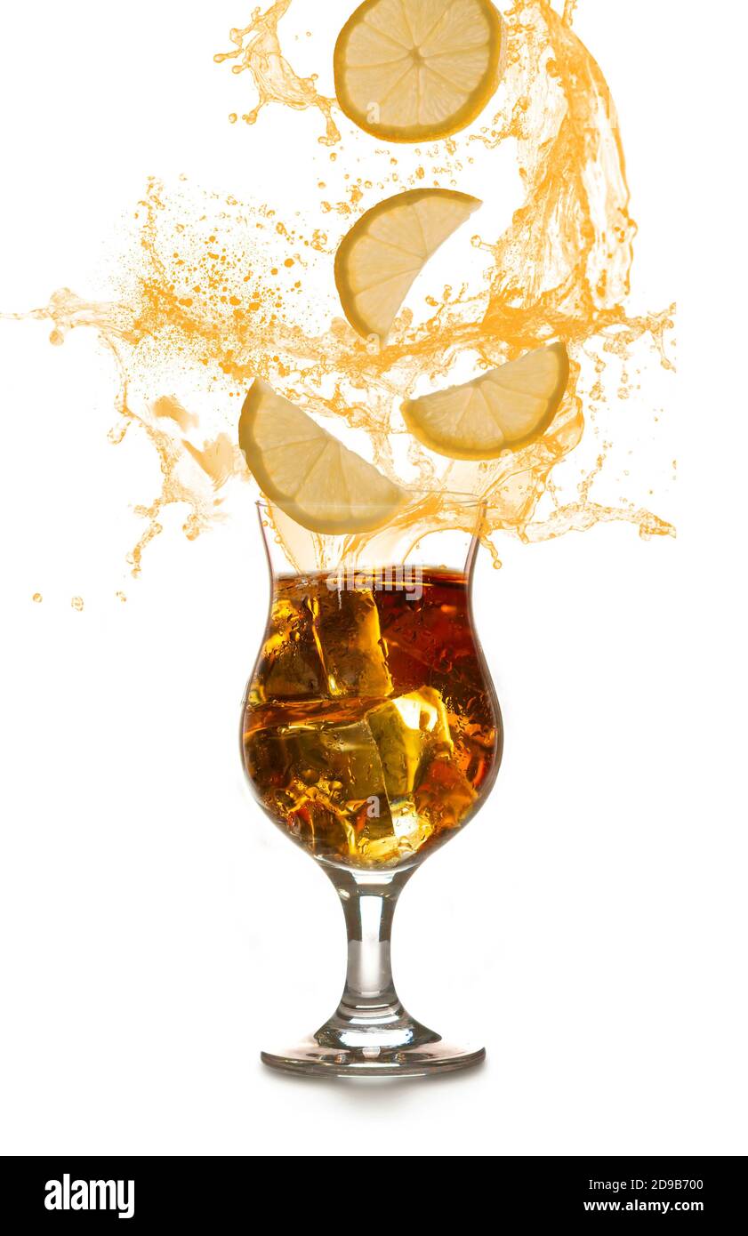 Glass of splashing iced tea with lemon on blue background. Picture with ...