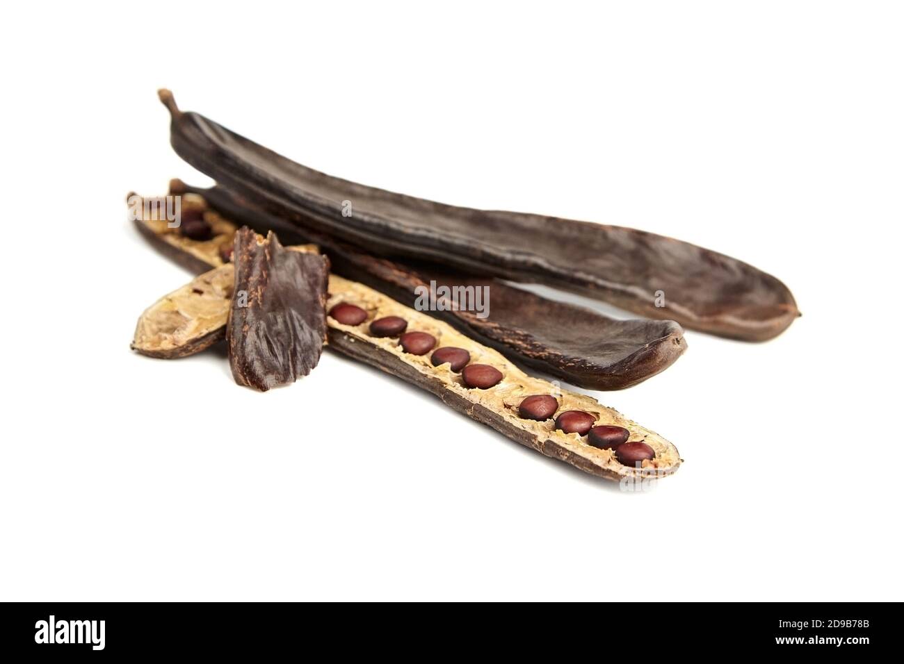 Dry carob beans with seeds isolated on white background. Healthy ...