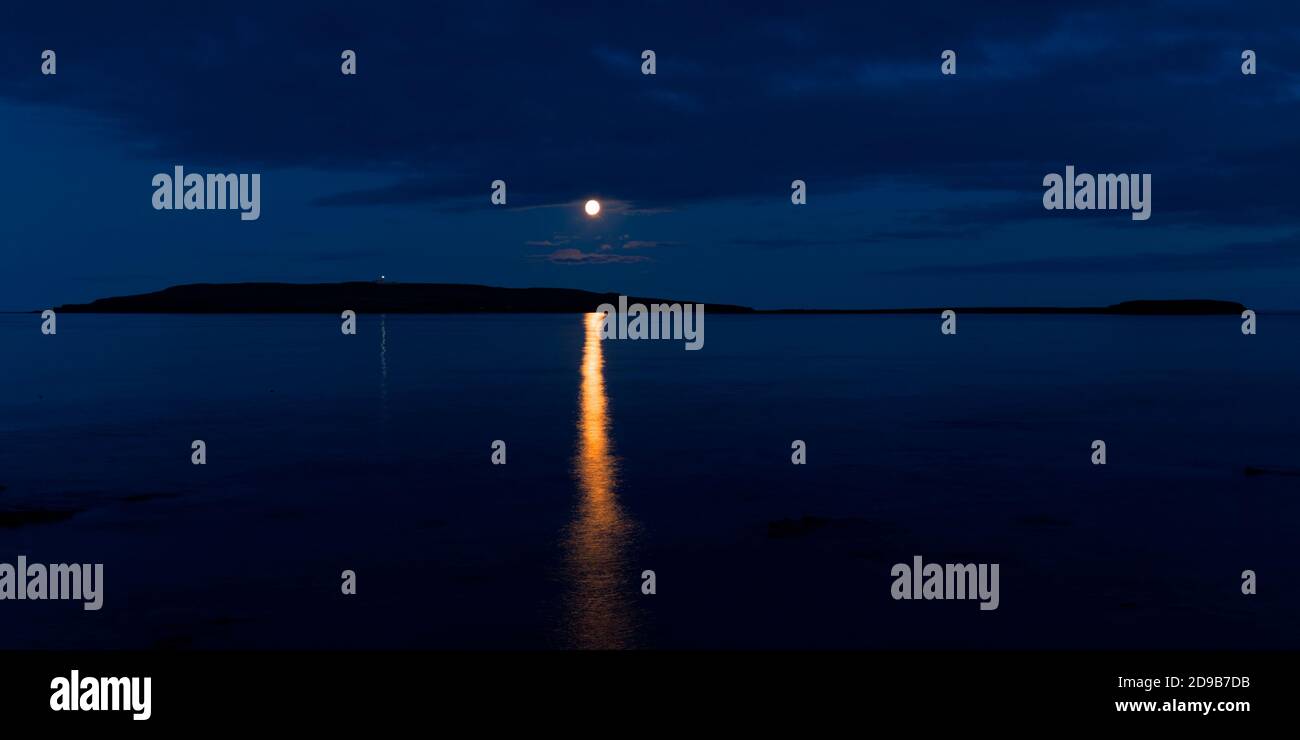 Copinsay island and lighthouse with full moon Stock Photo - Alamy