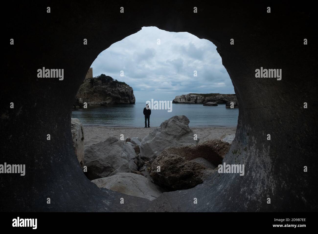 A man standing at the beach watching the sunrise hi-res stock ...