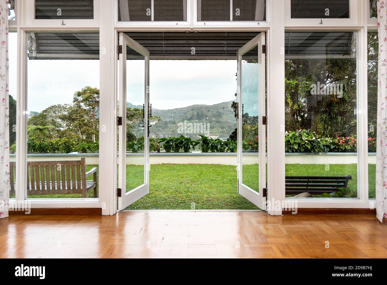 Glass door opening to refreshing, green, nature landscape scenic view ...