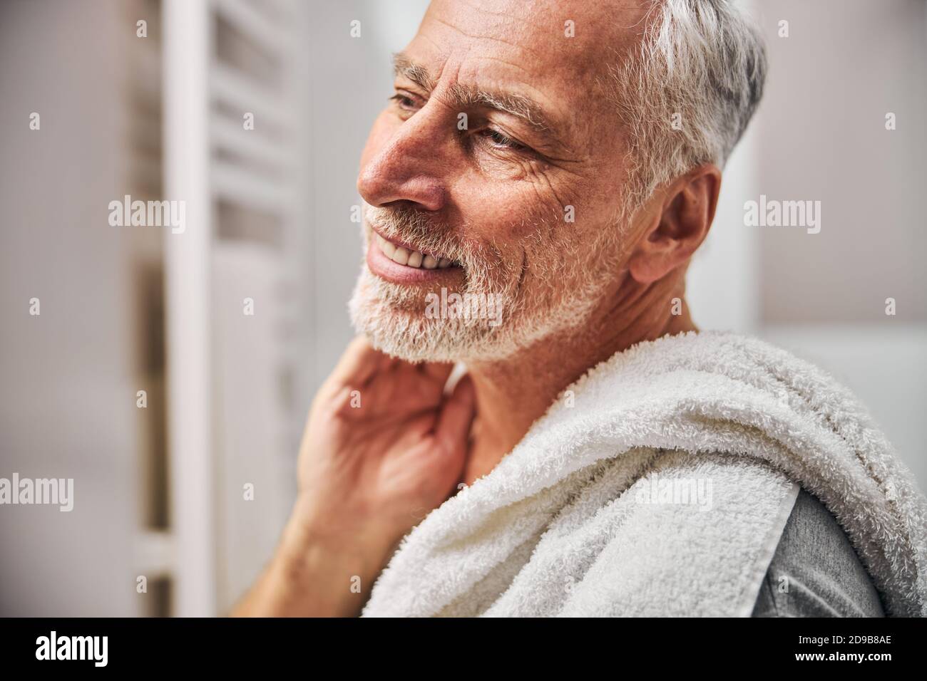Joyful senior citizen checking out his reflection in the mirror Stock ...