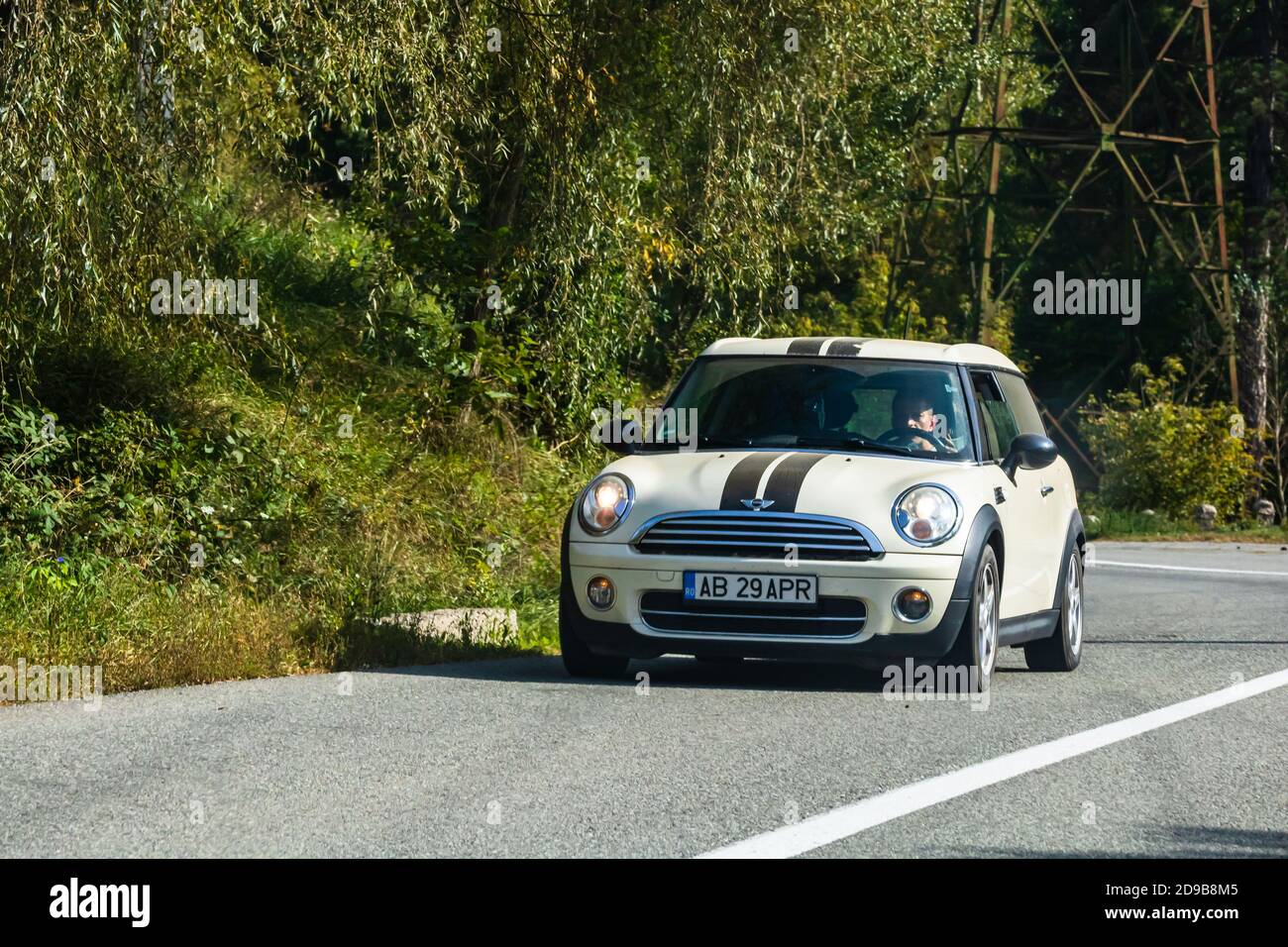 Traveling MINI car in motion on asphalt road, front view of car on ...