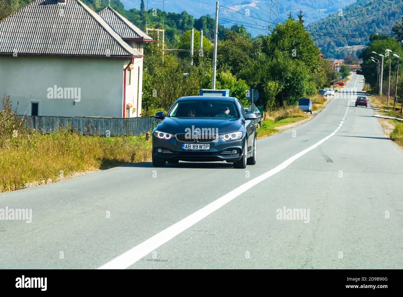 Traveling BMW car in motion on asphalt road, front view of car on ...