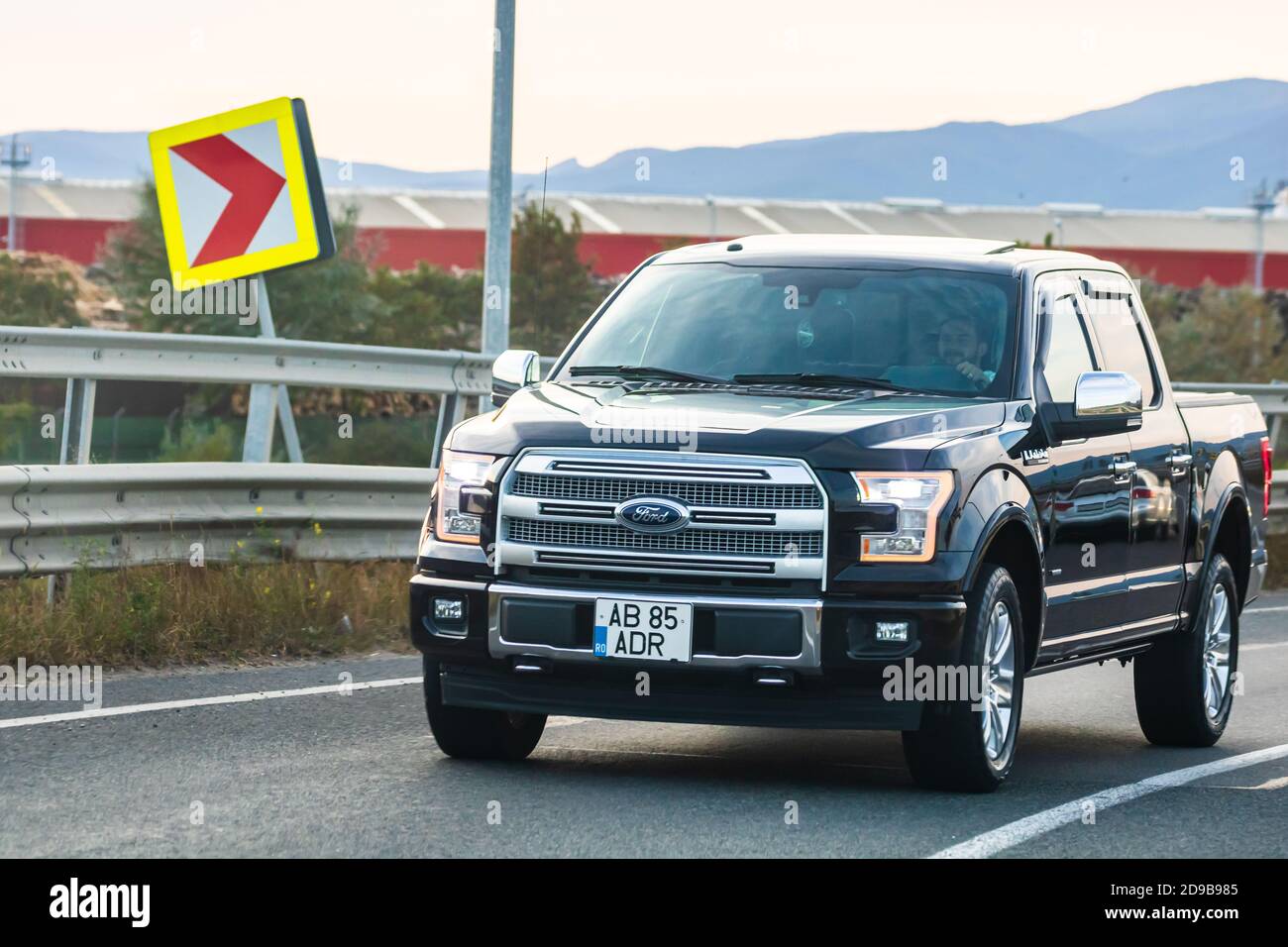 Traveling Ford Pickup car in motion on asphalt road, front view of car ...