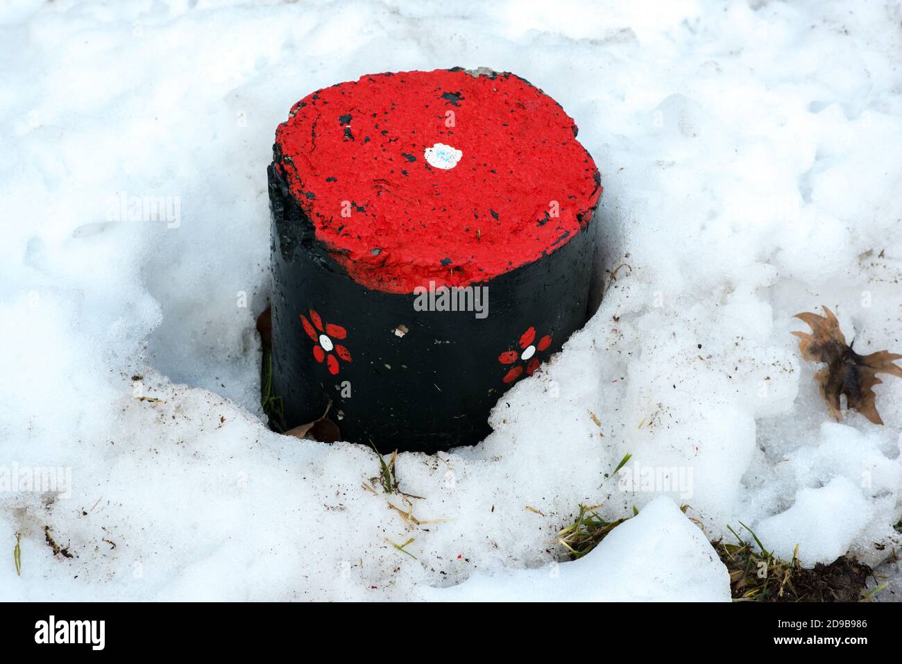 Painted stone in snow Stock Photo - Alamy