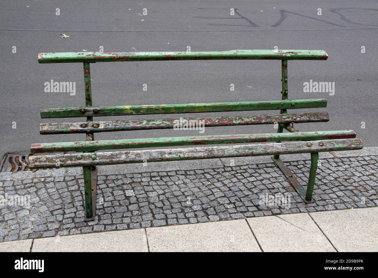 Old broken wooden bench on a walkway Stock Photo - Alamy