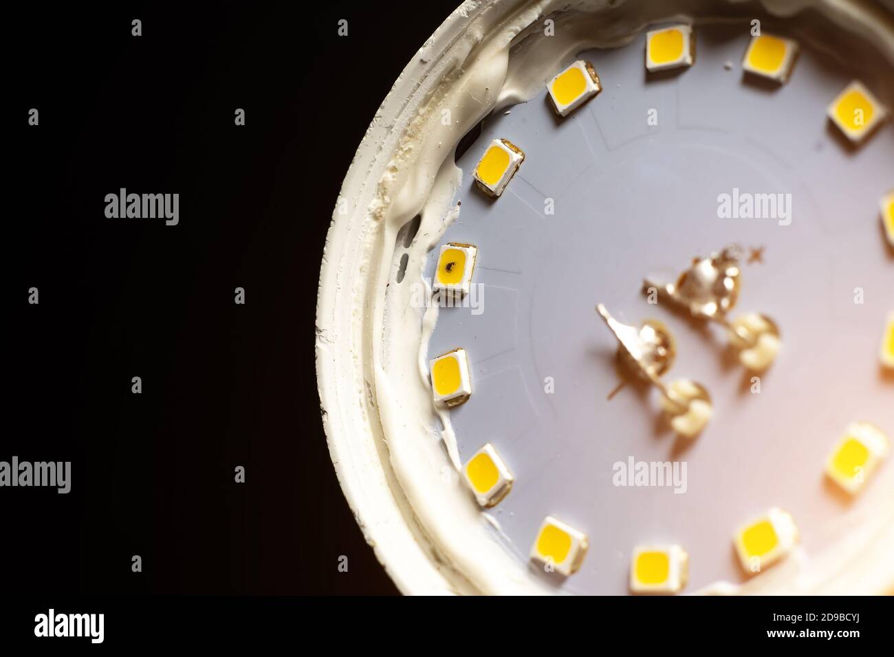 faulty led in an energy-saving lamp close-up on a black background ...