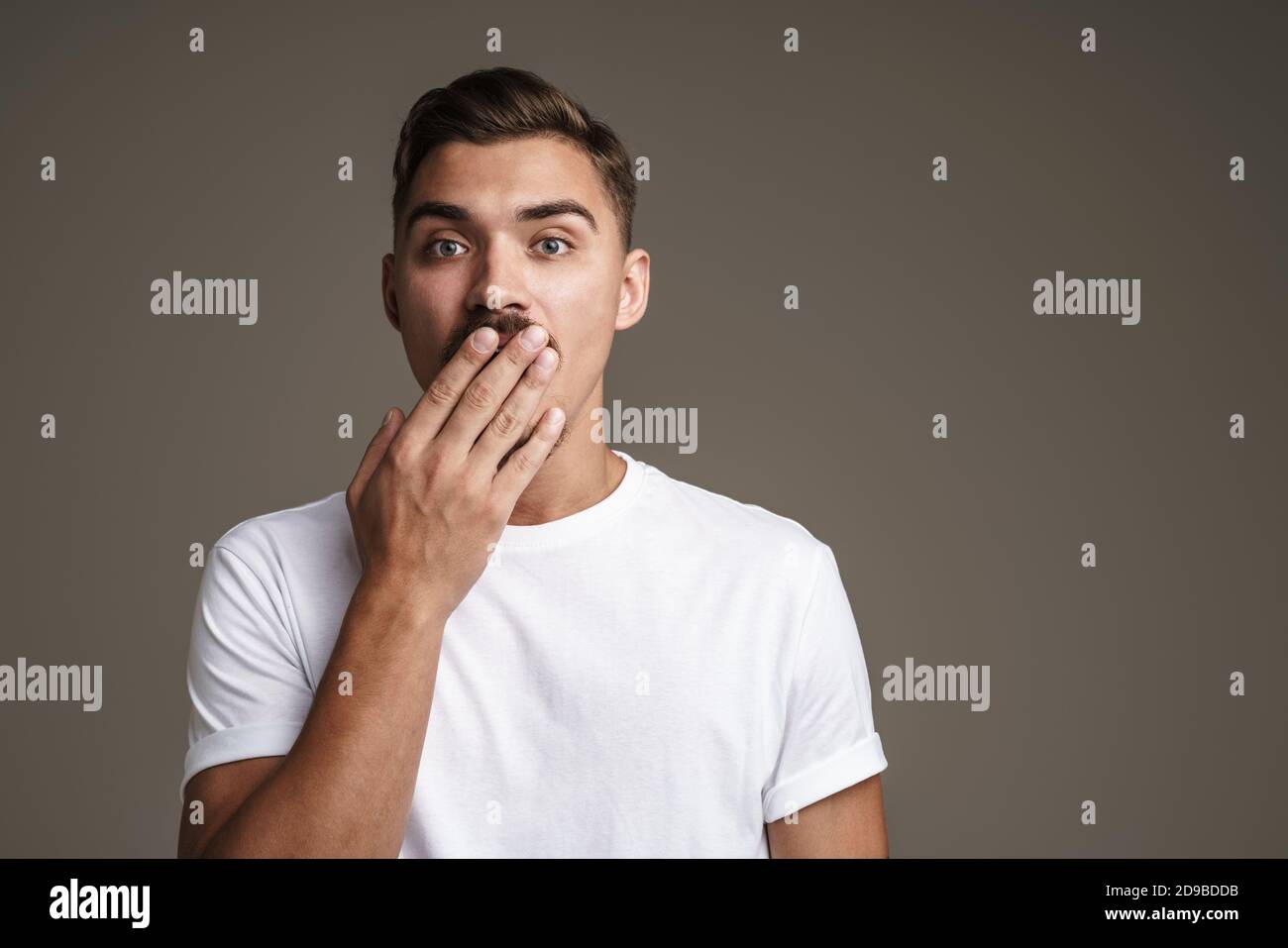 Image of shocked unshaven guy expressing surprise and covering his ...