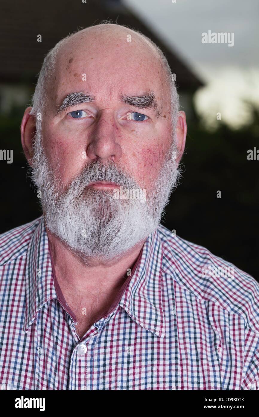 Portrait of a man in his 70s wearing a casual shirt Stock Photo - Alamy