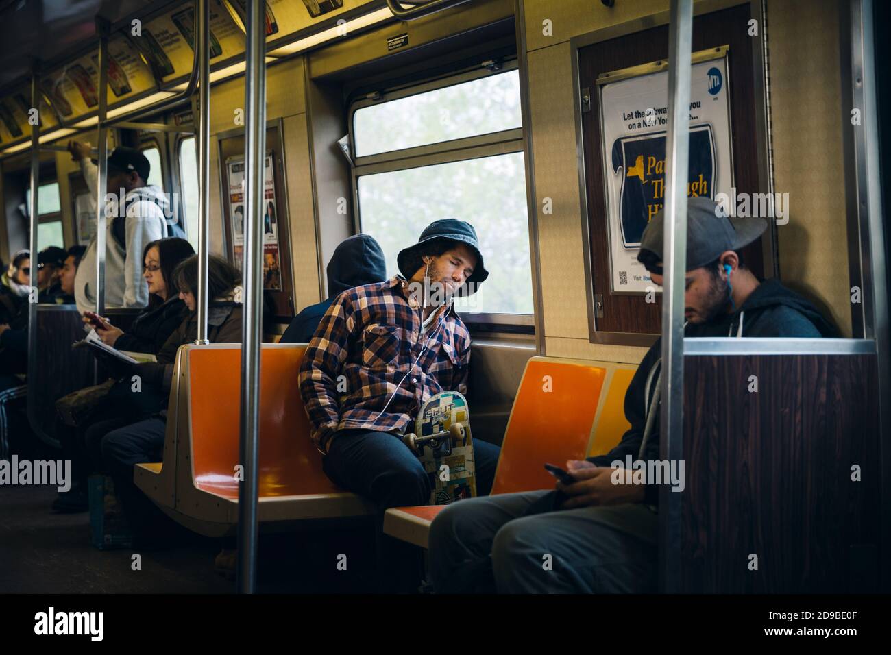 NEW YORK, USA - Apr 28, 2016: Commuters in New York subway wagon. Young ...