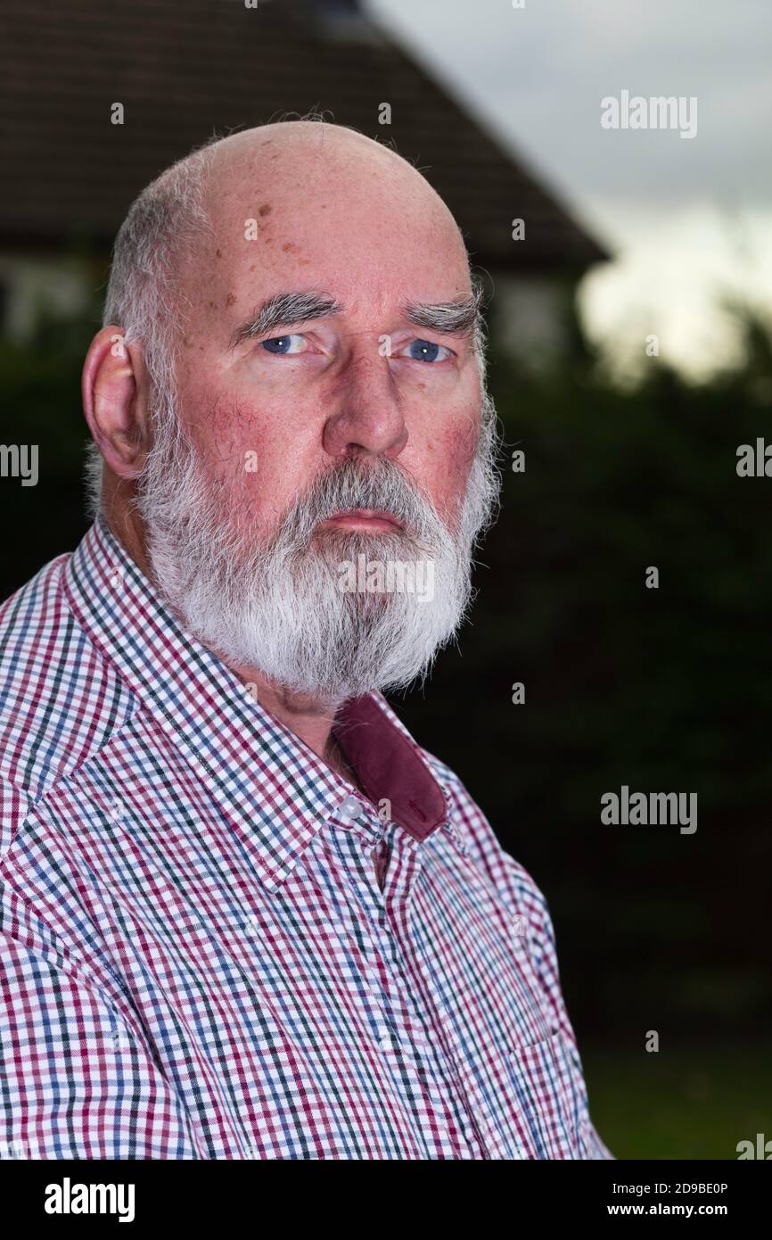 Portrait of a man in his 70s wearing a casual shirt Stock Photo - Alamy