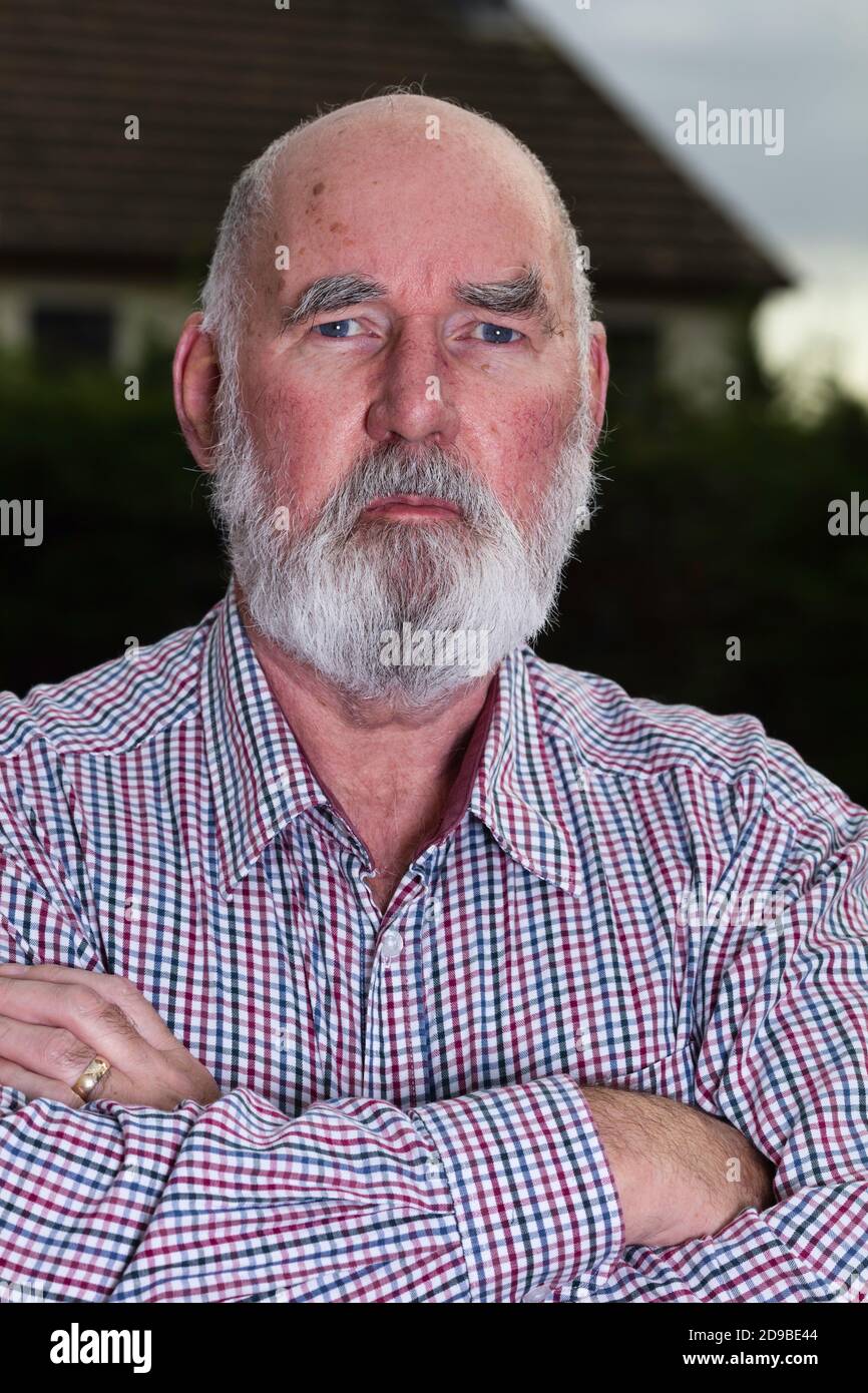 Portrait of a man in his 70s wearing a casual shirt Stock Photo - Alamy