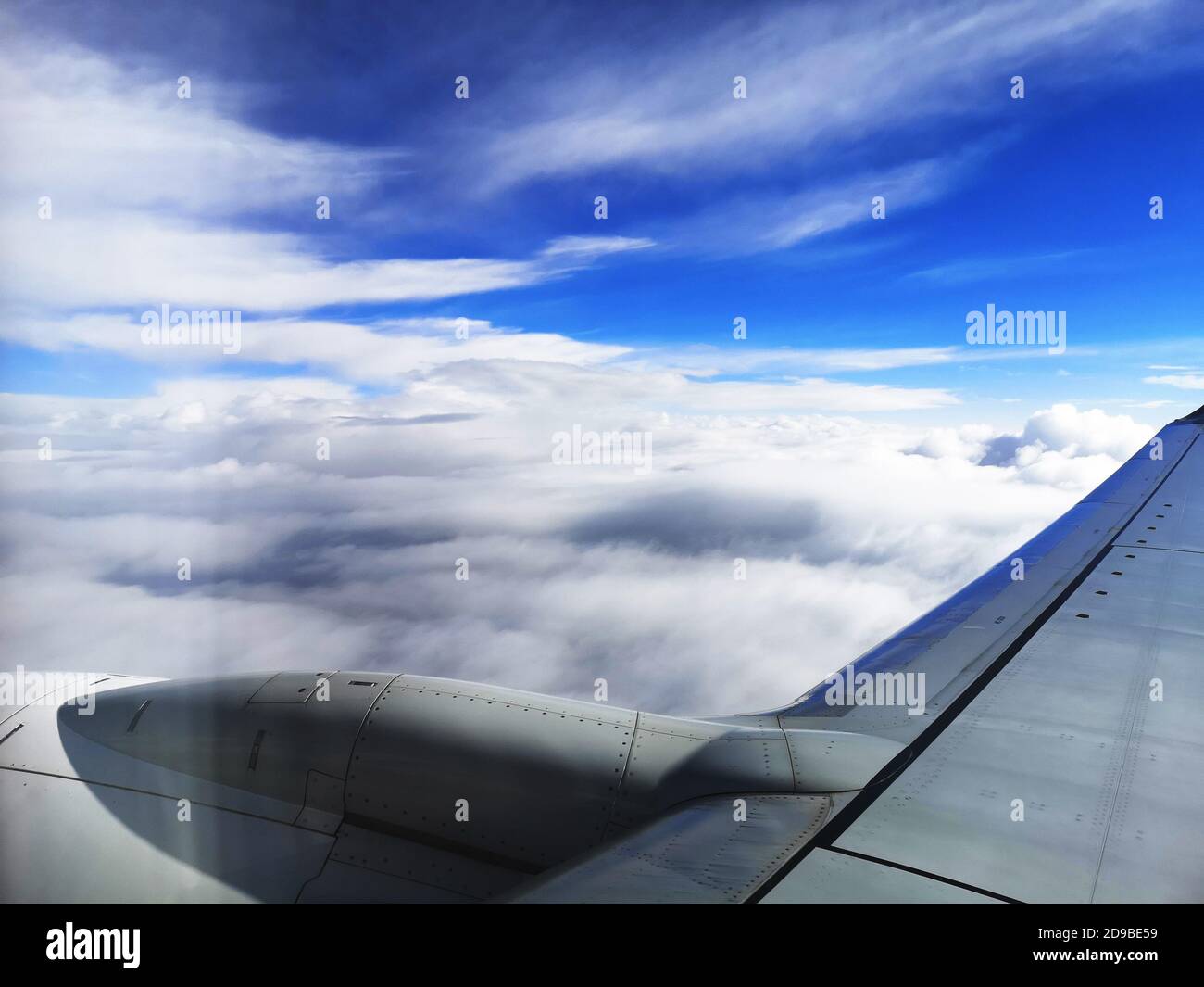 View of an aircraft wing flying above clouds Stock Photo - Alamy