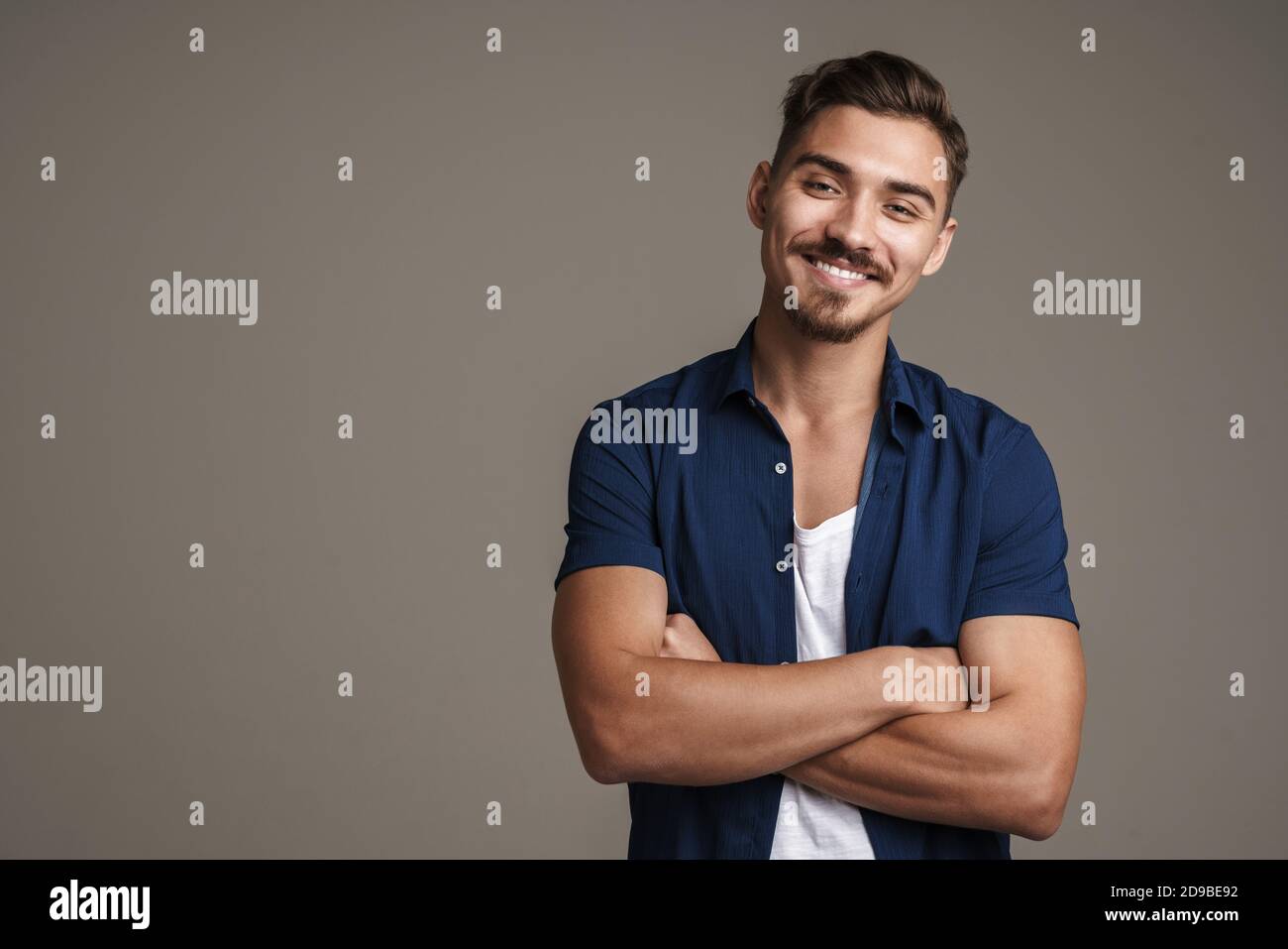 Image of joyful unshaven guy laughing while posing on camera isolated ...