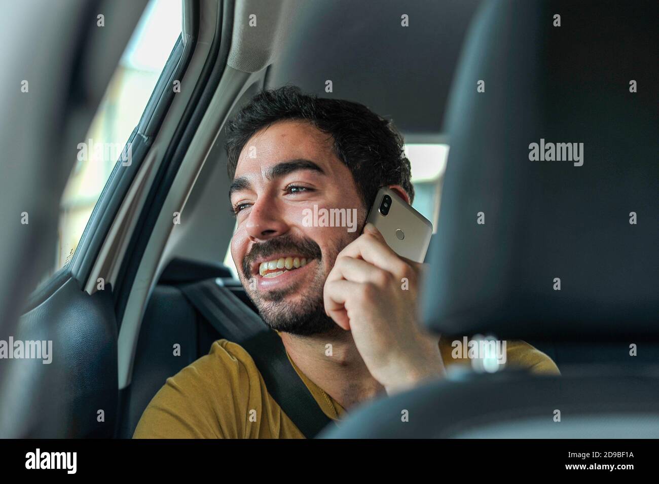 Young man chatting over phone in a car Stock Photo - Alamy