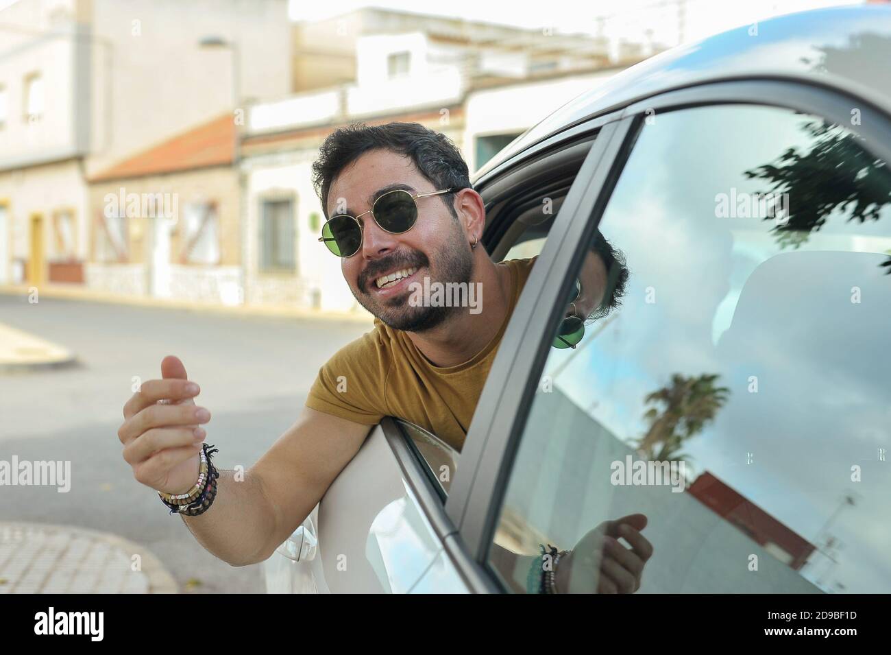 Bearded Man With Sunglasses Looking Out Of Car Window Stock Photo - Alamy