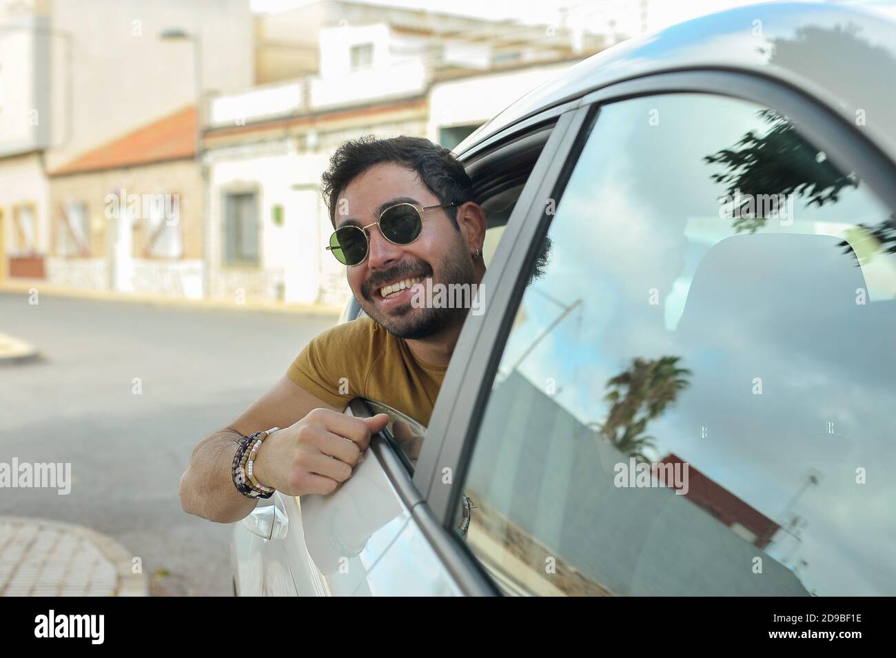 Bearded Man With Sunglasses Looking Out Of Car Window Stock Photo - Alamy