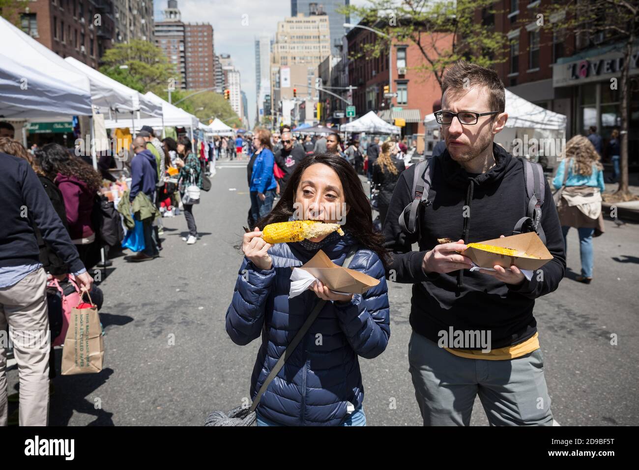 NEW YORK, USA - Apr 30, 2016: Young people eat corn on the streets of ...